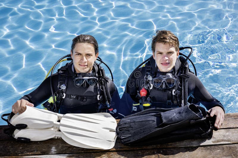 Two Scuba Divers Standing in a Pool, Looking at the Camera, Smiling ...