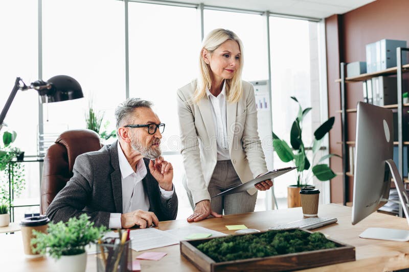 Senior Professionals Collaborating in Modern Office, Discussing ...