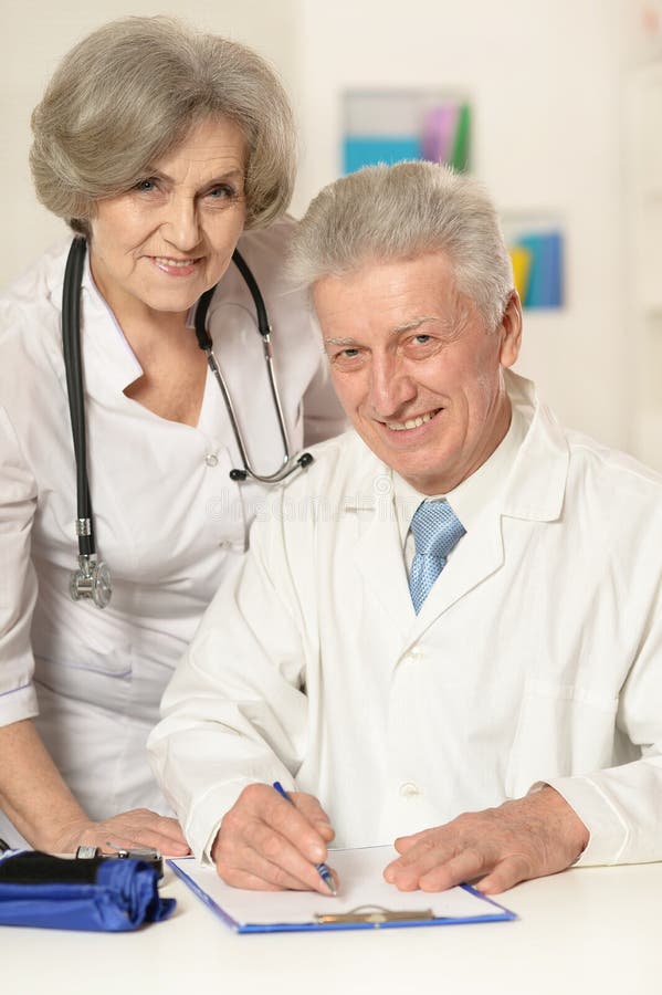 Senior Doctors Discussing Next To Machine in Hospital Stock Image ...