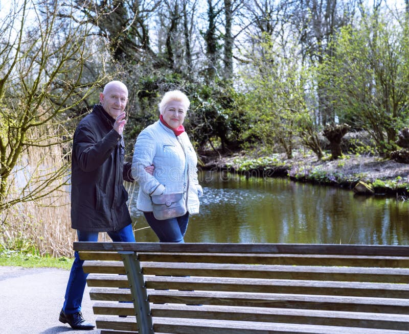 Two Seniors Seniors Walking in Spring Park Stock Photo - Image of ...