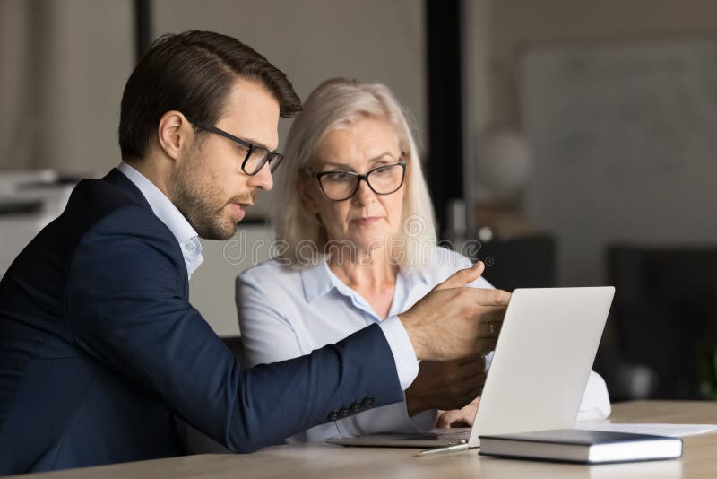 Two Serious Business Colleagues Collaborating on Internet Project at ...