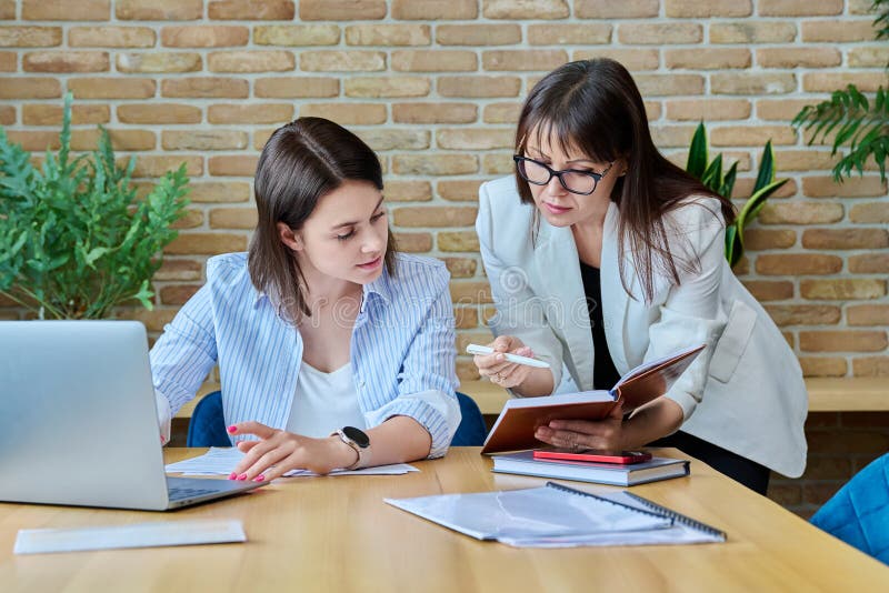 Two Serious Business Women Working in Office, with Papers Stock Image ...