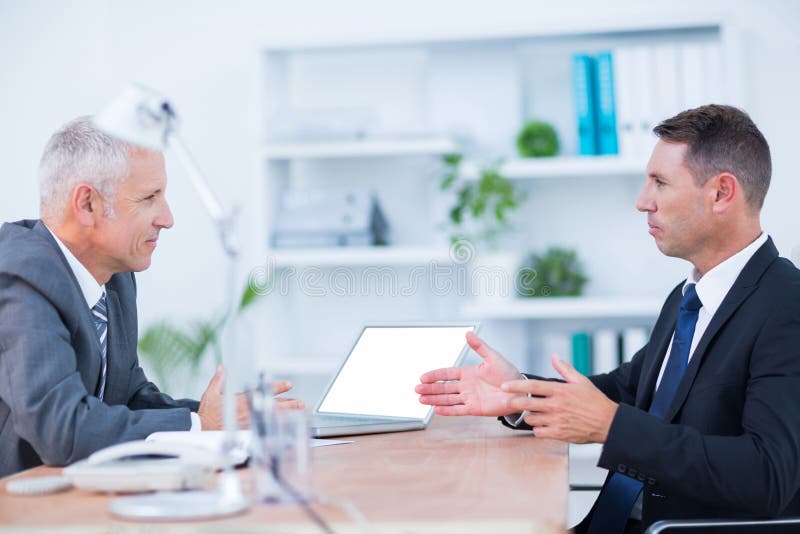 Serious Businessmen Working Together Leaning on the Desk Stock Photo ...
