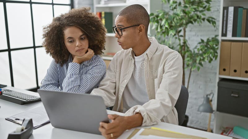 Two Serious-faced Workers, a Man and Woman, Intensely Working Together ...