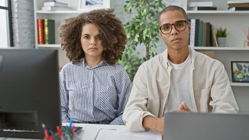 Two Serious-faced Workers, a Man and Woman, Intensely Working Together ...