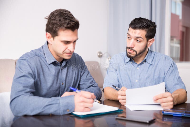 Two Serious Men with Documents at Table Stock Photo - Image of ...