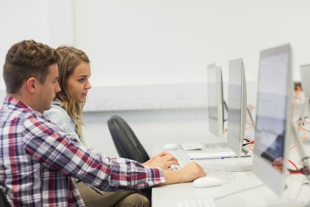 Two Serious Students Working on Computer Stock Photo - Image of sitting ...