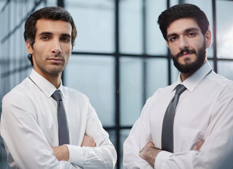 Two Serious Young Businessmen Standing with in Office Stock Image ...