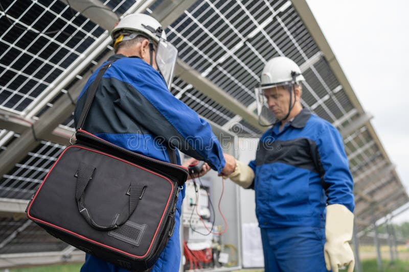 Two Service Engineers or Electrician Working on Checking Transformer ...