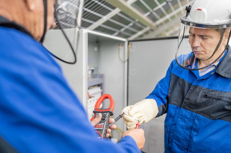 Two Service Engineers or Electrician Working on Checking Transformer ...