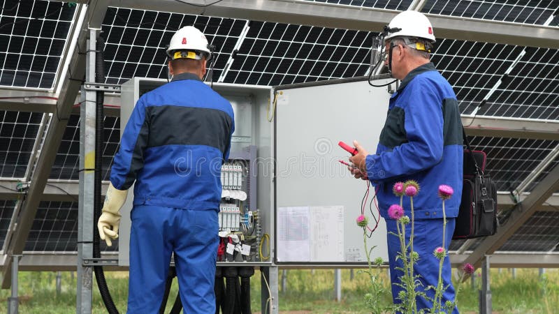 Two Service Engineers or Electrician Working on Checking Transformer ...