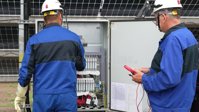 Two Service Engineers or Electrician Working on Checking Transformer ...