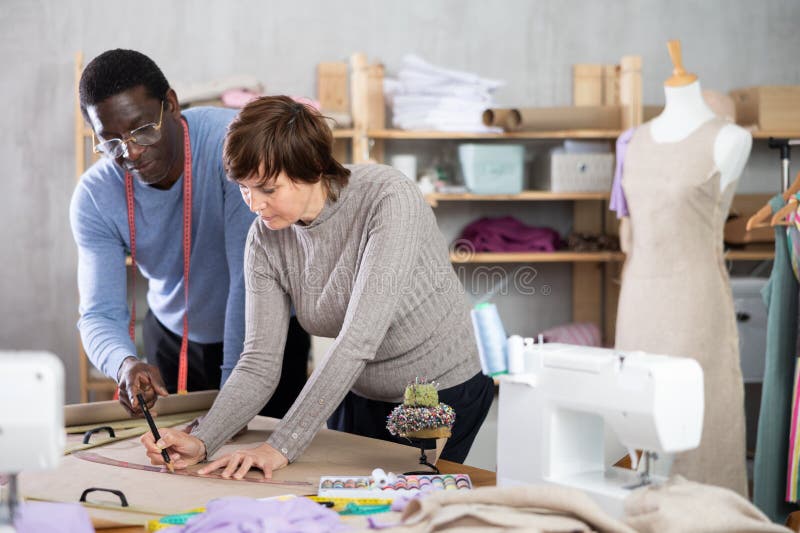 Two Sewing Workshop Workers Draw Patterns on Paper Stock Photo - Image ...