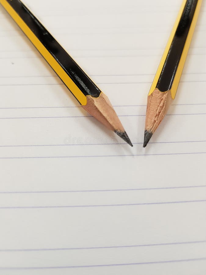 Two Sharpened Pencil Over a Ruled White Paper Stock Image - Image of ...