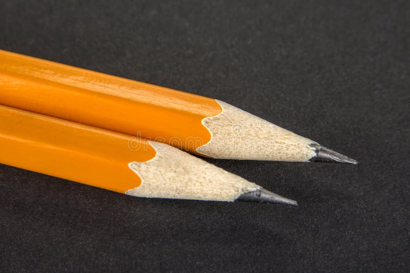 Two Orange Pencils Between Black Pencils Stock Image - Image of pencils ...