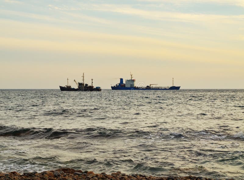 Two ships apart in sea stock image. Image of dark, dusk - 48610309