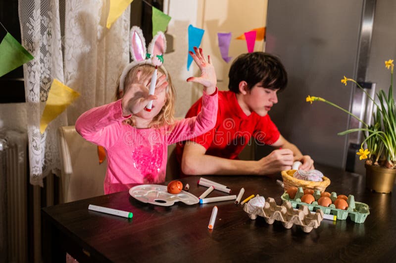 Two Siblings Crafting Festive Easter Eggs at Home during a Joyful ...