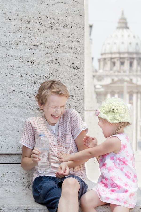 Two Siblings Having Fun with Water from Plastic Bottle in Hot Summer ...