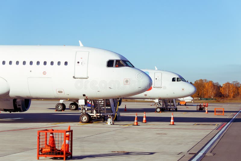 Two Side Profile Parked Airplanes with Windows of Wide-body Airplane ...