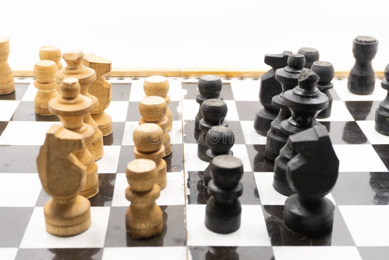 Two Sides of Black and White Chess Pieces, Which are Made of Wood, are ...