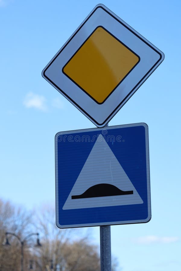 Two Signs with Arrows Pointing Directions, on a Bright Blue and Yellow ...