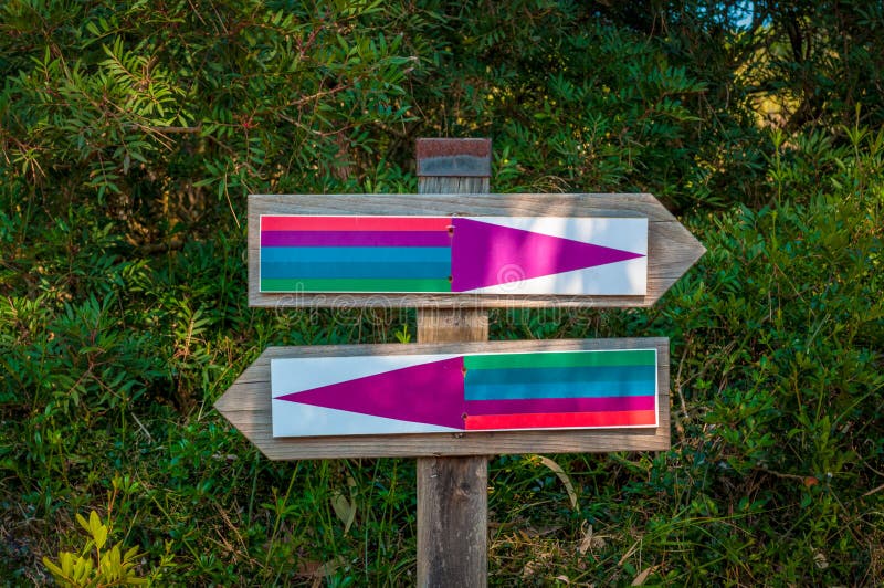 Two Signs for Opposite Directions in the Park Stock Photo - Image of ...