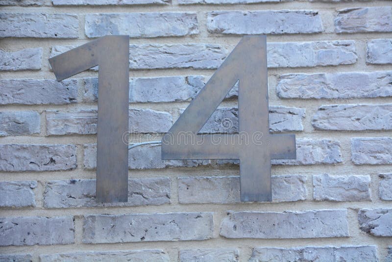 Two Silver Metallic Digits Fixed on a Wall and Showing the Number ...