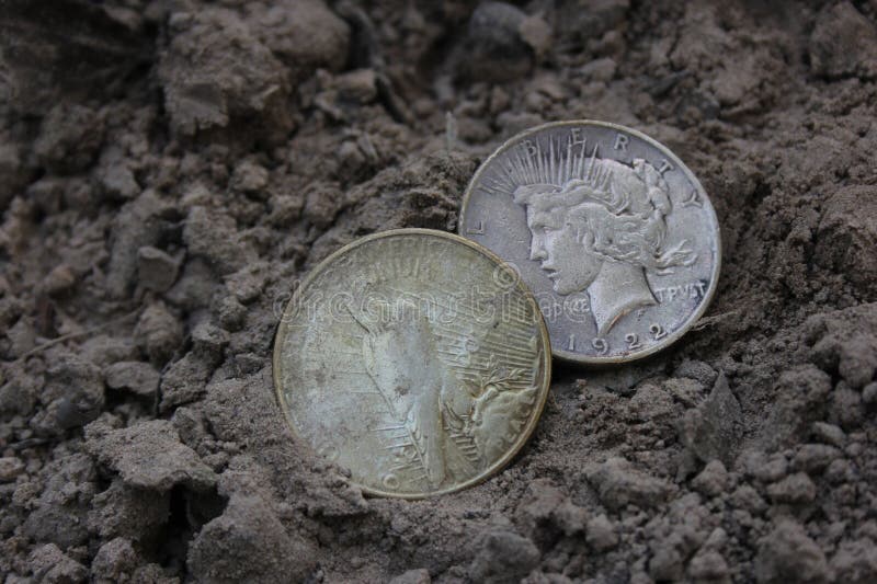 Two 1922 Silver Peace Dollars on Ground in Dirt Stock Image - Image of ...