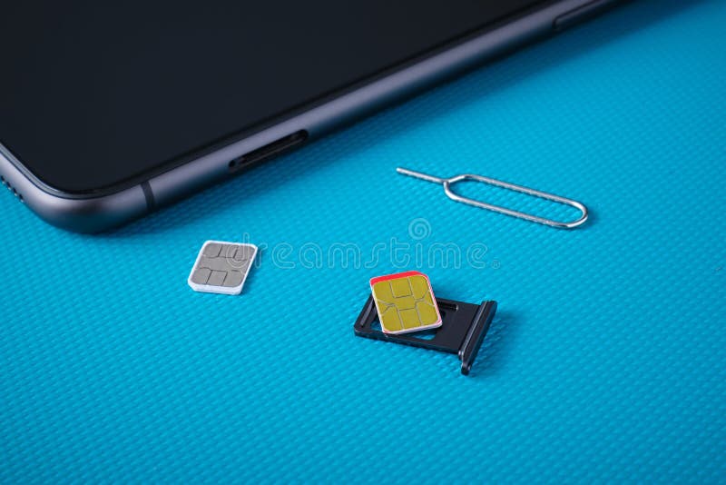 Two Sim Cards Lying Next To a Dark Smartphone Stock Photo - Image of ...