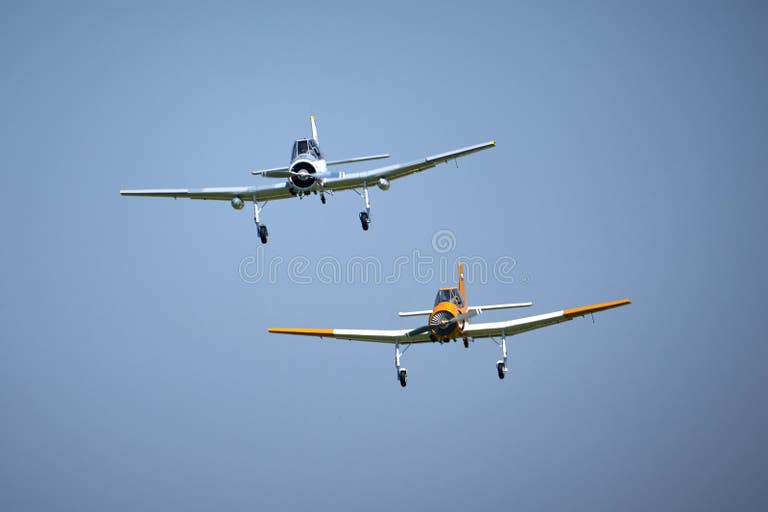 Two Single-engine Propeller Planes Fly in Close Formation Against a ...