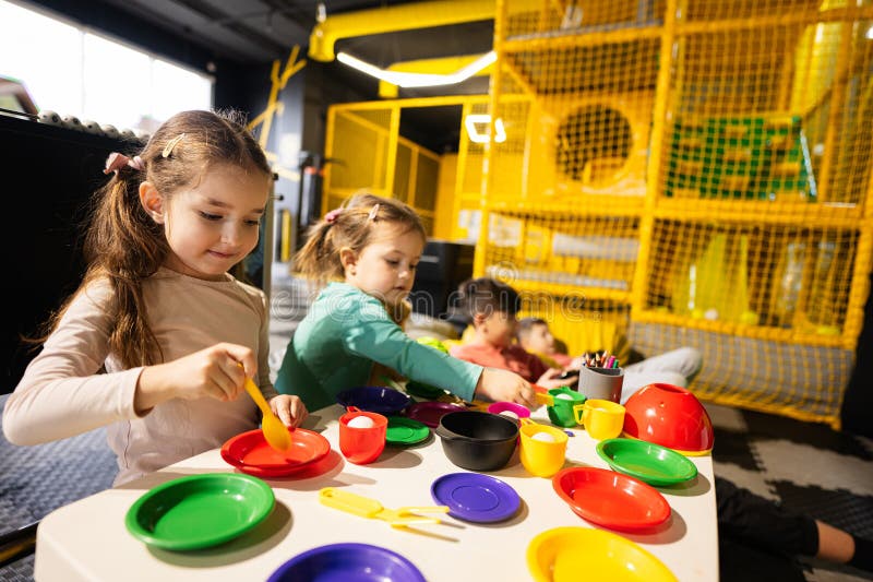 Two Sisrers Playing in Kids Kitchen at Children Play Center Stock Photo ...