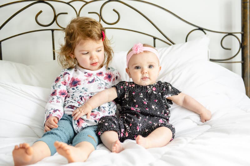 The Two Sister Baby in White Bed at Home Stock Photo - Image of indoors ...