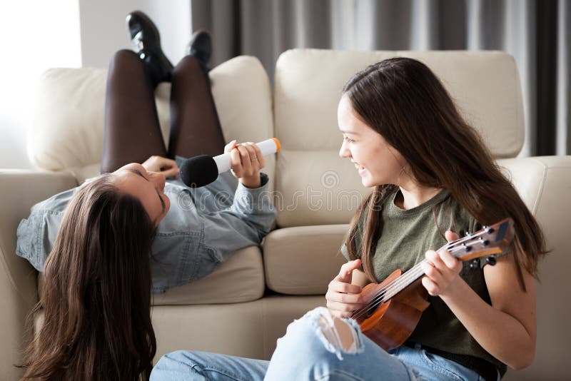 Two Sisters Alone in the House Having Fun and Playing Stock Photo ...
