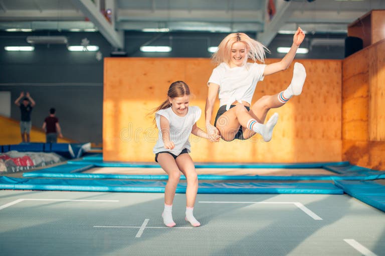 Mother and Daughter Jumping on Trampoline and Doing Split Stock Image ...