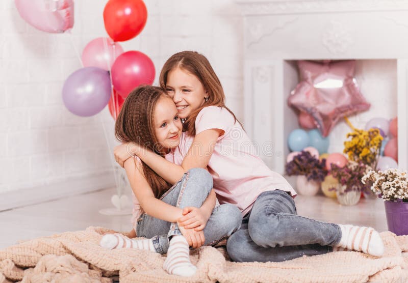Two Sisters Children Cuddle in Festively Decorated Room Stock Image ...