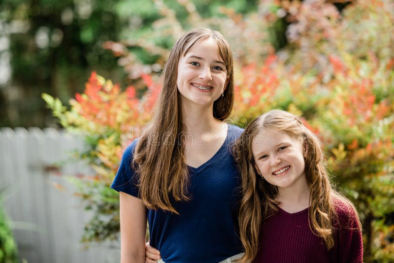 Two Sisters Embracing Outside in the Spring Stock Photo - Image of ...