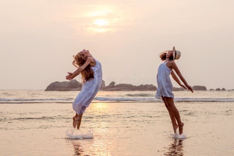 Two Sisters Having Fun at the Sea at the Sunset Stock Image - Image of ...