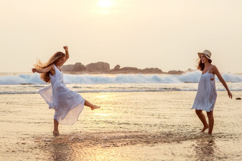 Two Sisters Having Fun at the Sea at the Sunset Stock Image - Image of ...