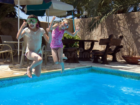 Two Sisters Jumping in the Pool Stock Image - Image of summer, vacation ...