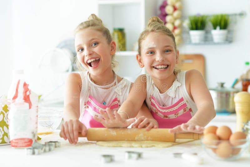Two sisters in the kitchen stock photo. Image of home - 115073758