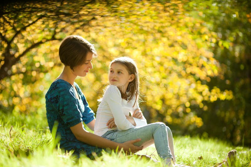 Two Sisters in a Park in Autumn Stock Photo - Image of family, green ...