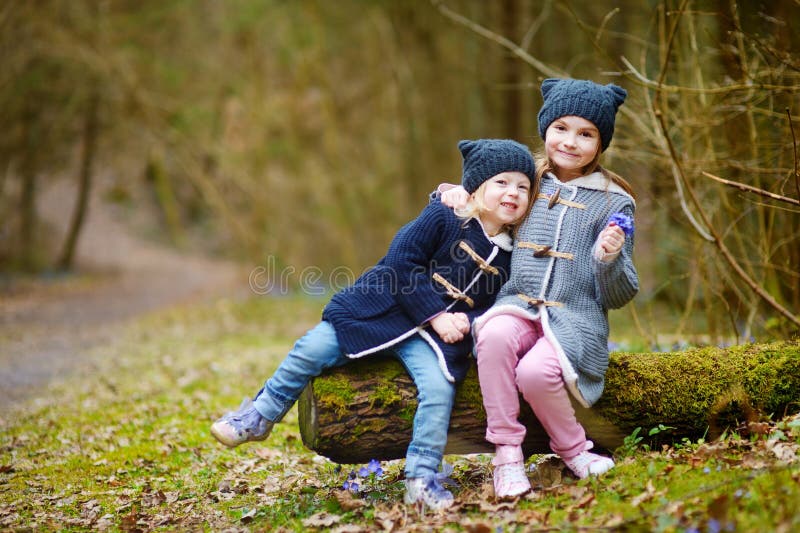 Two Sisters Picking the First Flowers of Spring Stock Image - Image of ...