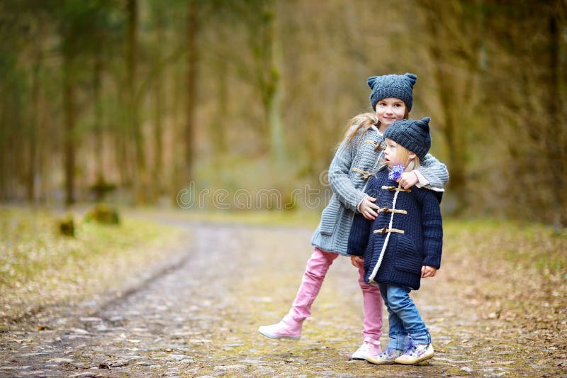 Two Sisters Picking the First Flowers of Spring Stock Image - Image of ...