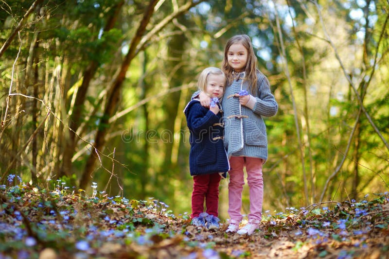 Two Sisters Picking the First Flowers of Spring Stock Image - Image of ...