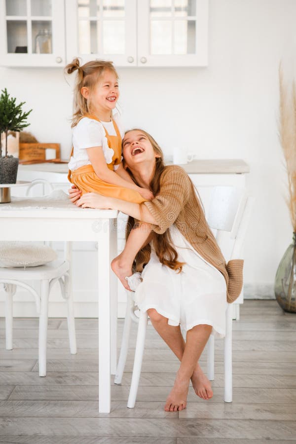 Two Sisters Play in a Bright, Stylish Kitchen. Beautiful Interior Stock ...
