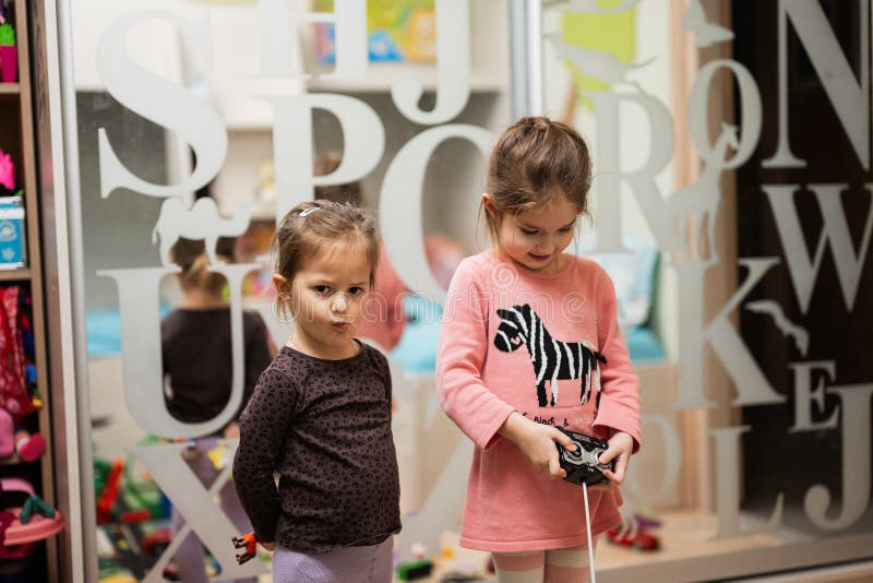 Two Sisters Play Remote Control in Children`s Room Stock Image - Image ...