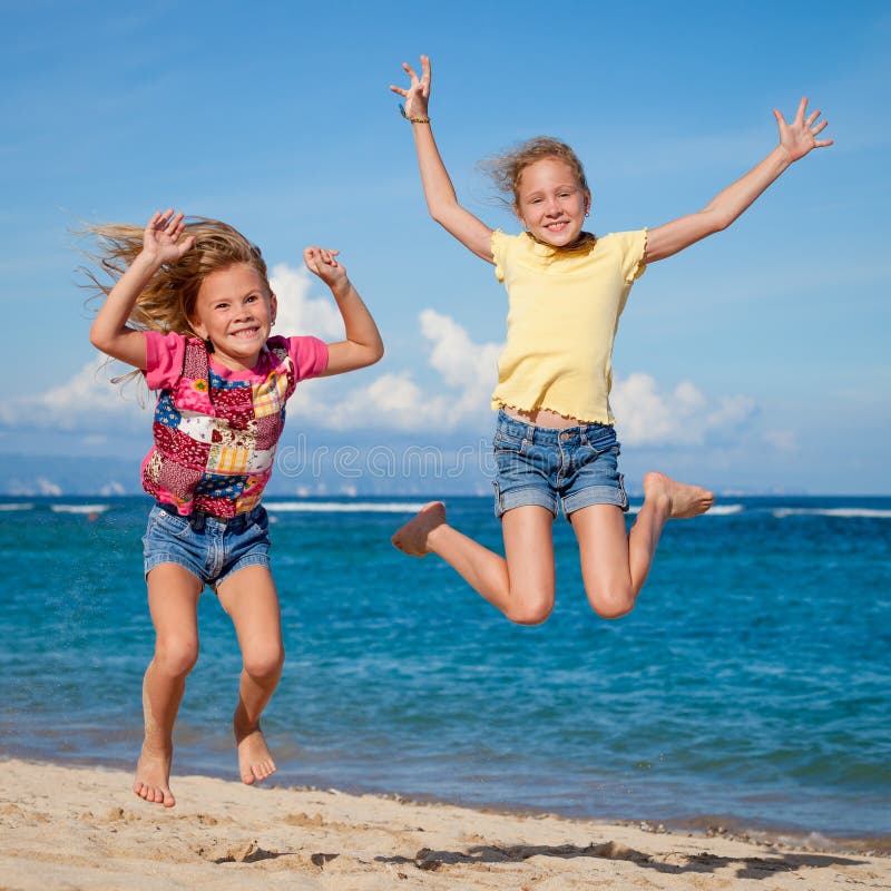 Two Sisters Playing on the Beach Stock Photo - Image of friendship ...
