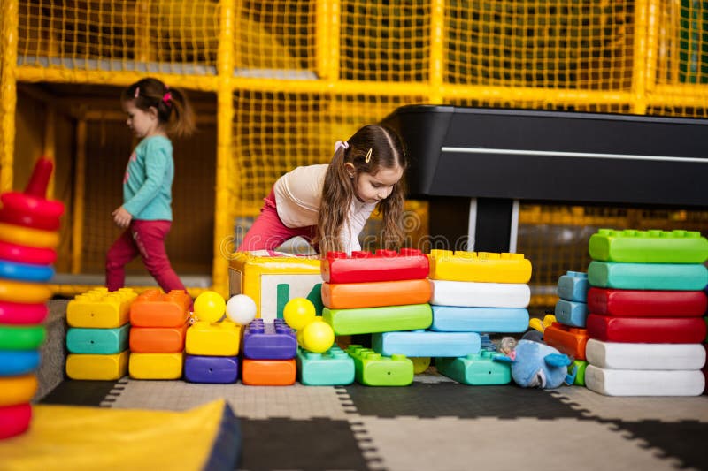 Two Sisters Playing at Kids Play Center while Build with Colored ...