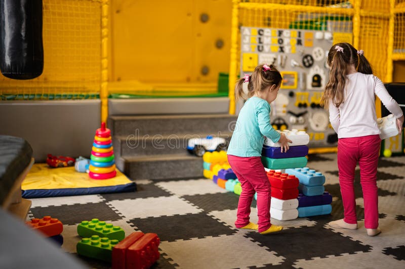 Two Sisters Playing at Kids Play Center while Build with Colored ...