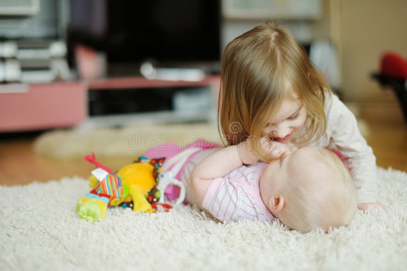 Two Sisters Playing Together Stock Photo - Image of baby, expression ...